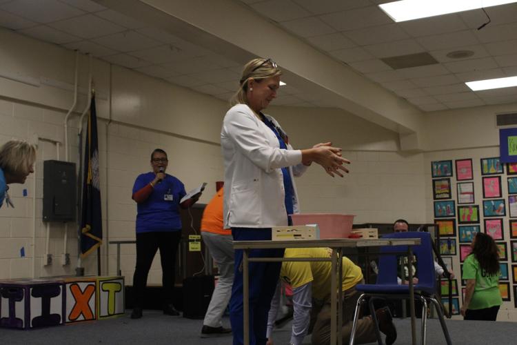 Local students learn proper hand hygiene skills with demo