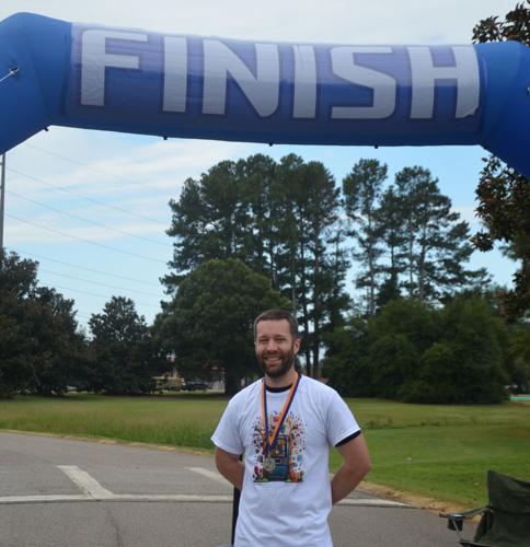 Aiken community members run to raise funds for a book vending machine
