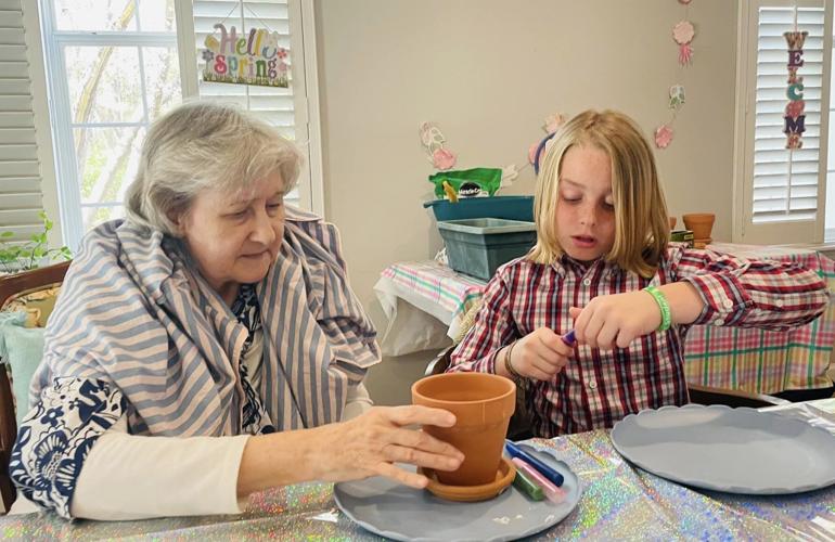 Assisted living community residents enjoy indoor gardening activity