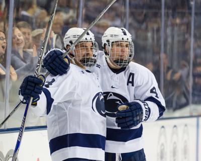 Former men’s hockey forward Tommy Olczyk jokes around with freshman ...