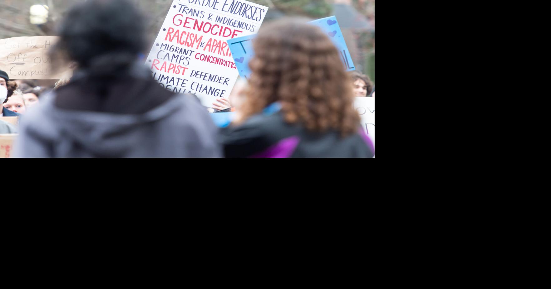 3/23/23 Michael Knowles visits campus, Sign held up at speakers ...