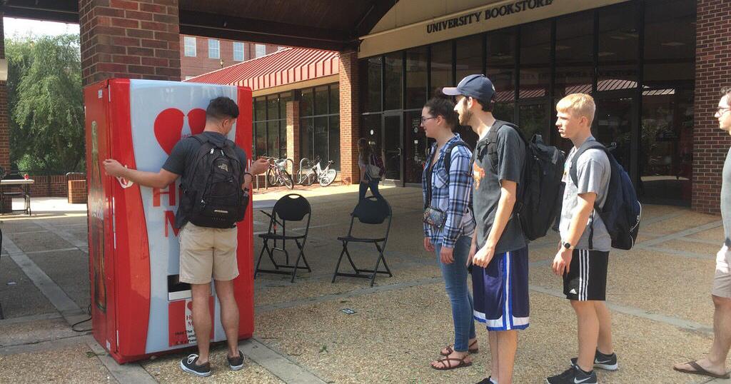Visiting Coca-Cola vending machine offers free sodas for a hug | Campus ...