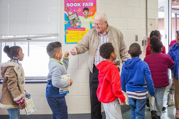 The gift of reading: Kiwanis members send books home with students in ...