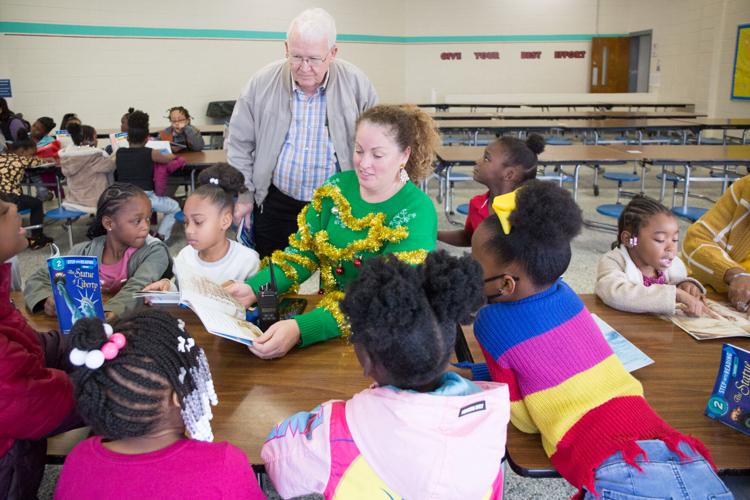 The gift of reading: Kiwanis members send books home with students in ...