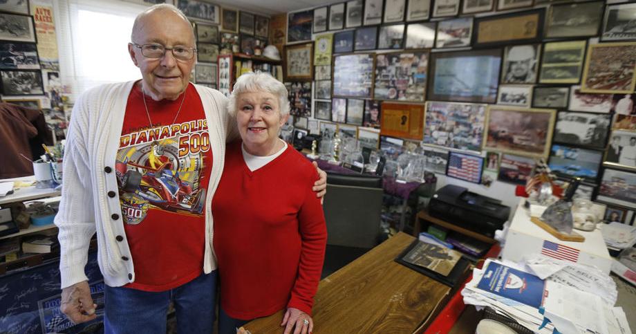Joe and Ruth Kelly wave checkered flag on auto racing talk show