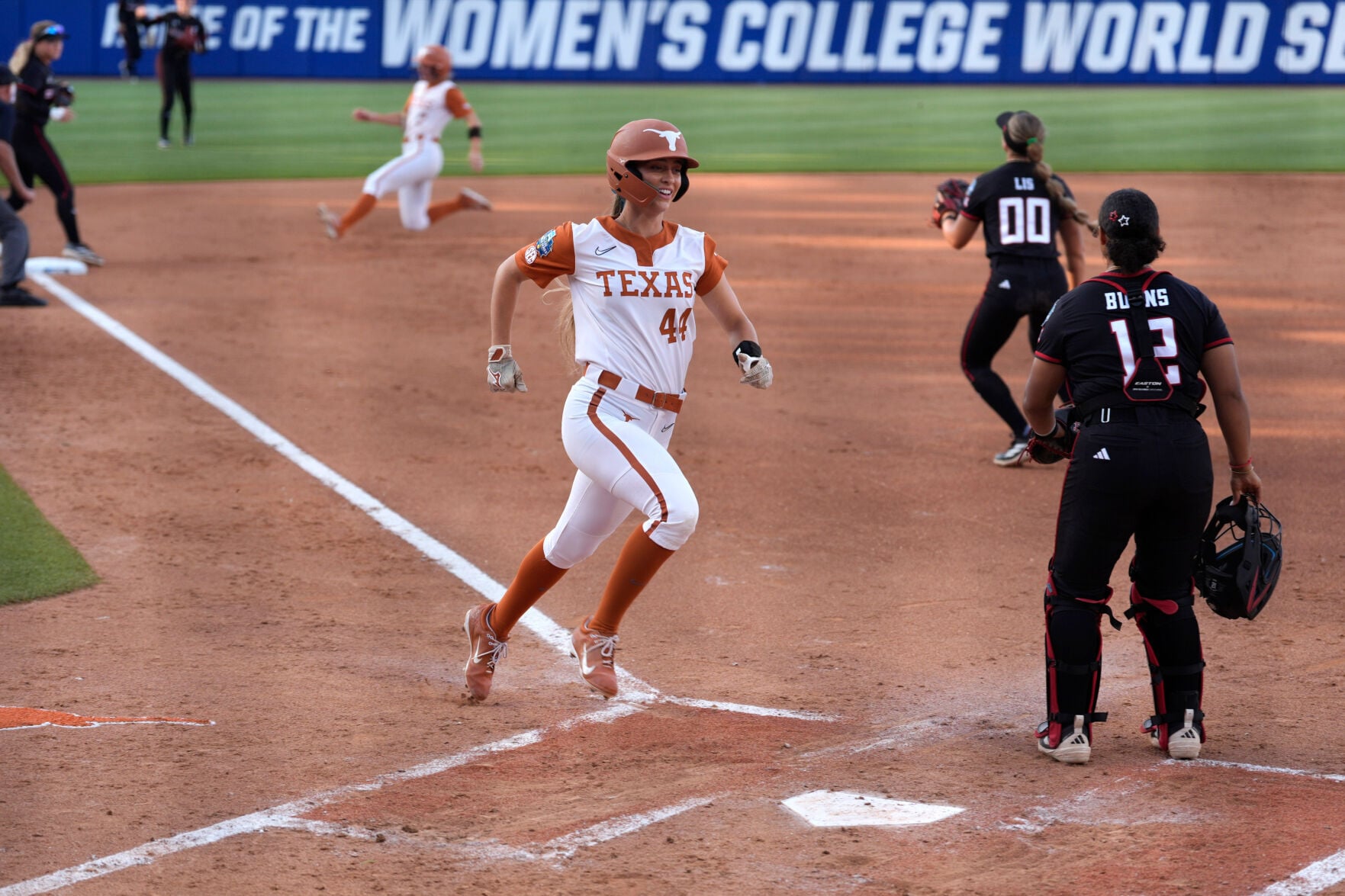 Texas Longhorns utility Kaiah Altmeyer (44) scores a run in the first ...