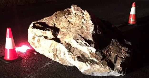 Meteorite? Far-fetched. Landscaping boulder? Probably. A car hit it and ...