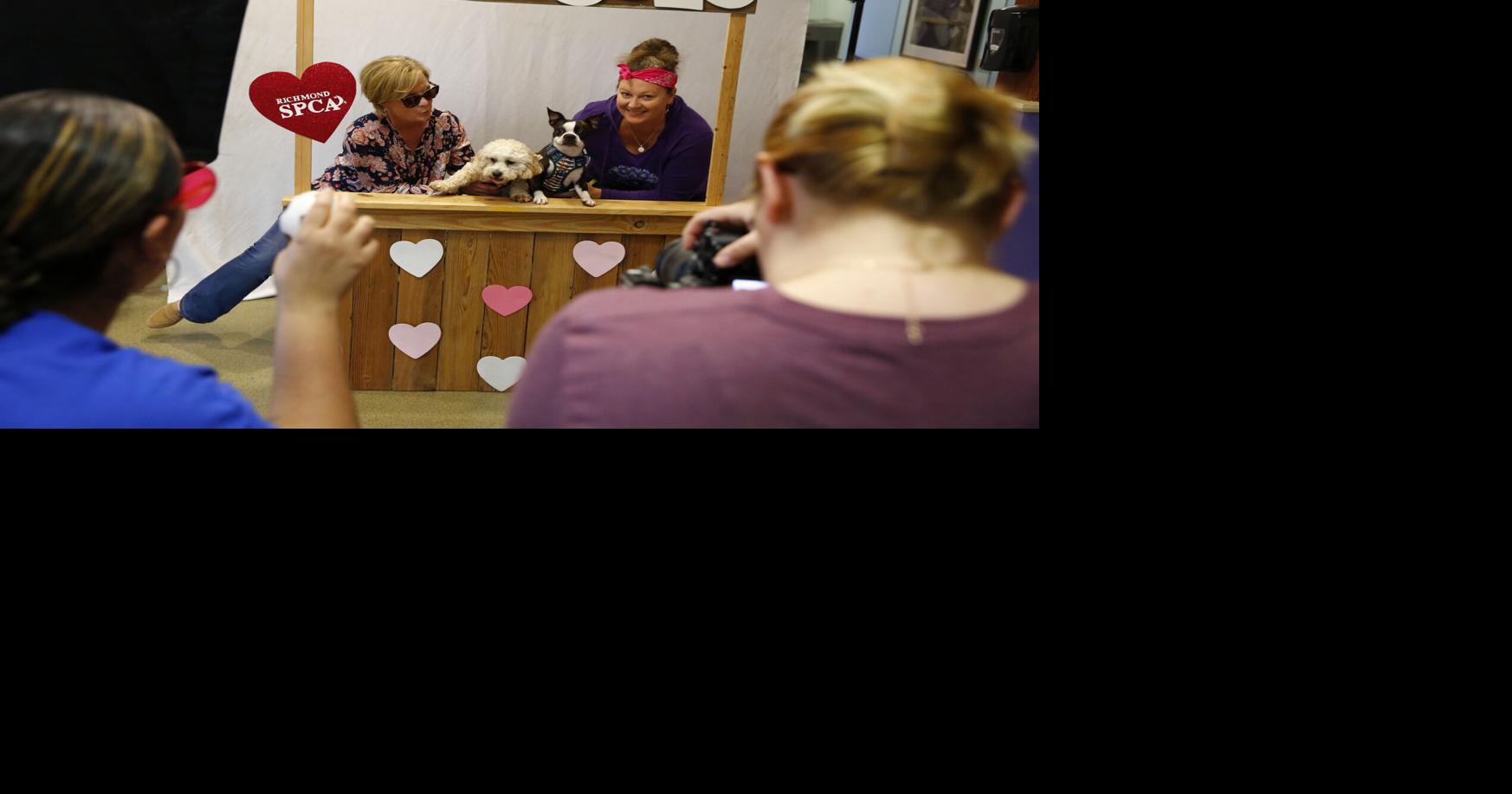 Pet owners and their pooches pucker up for the Dog Kissing Booth
