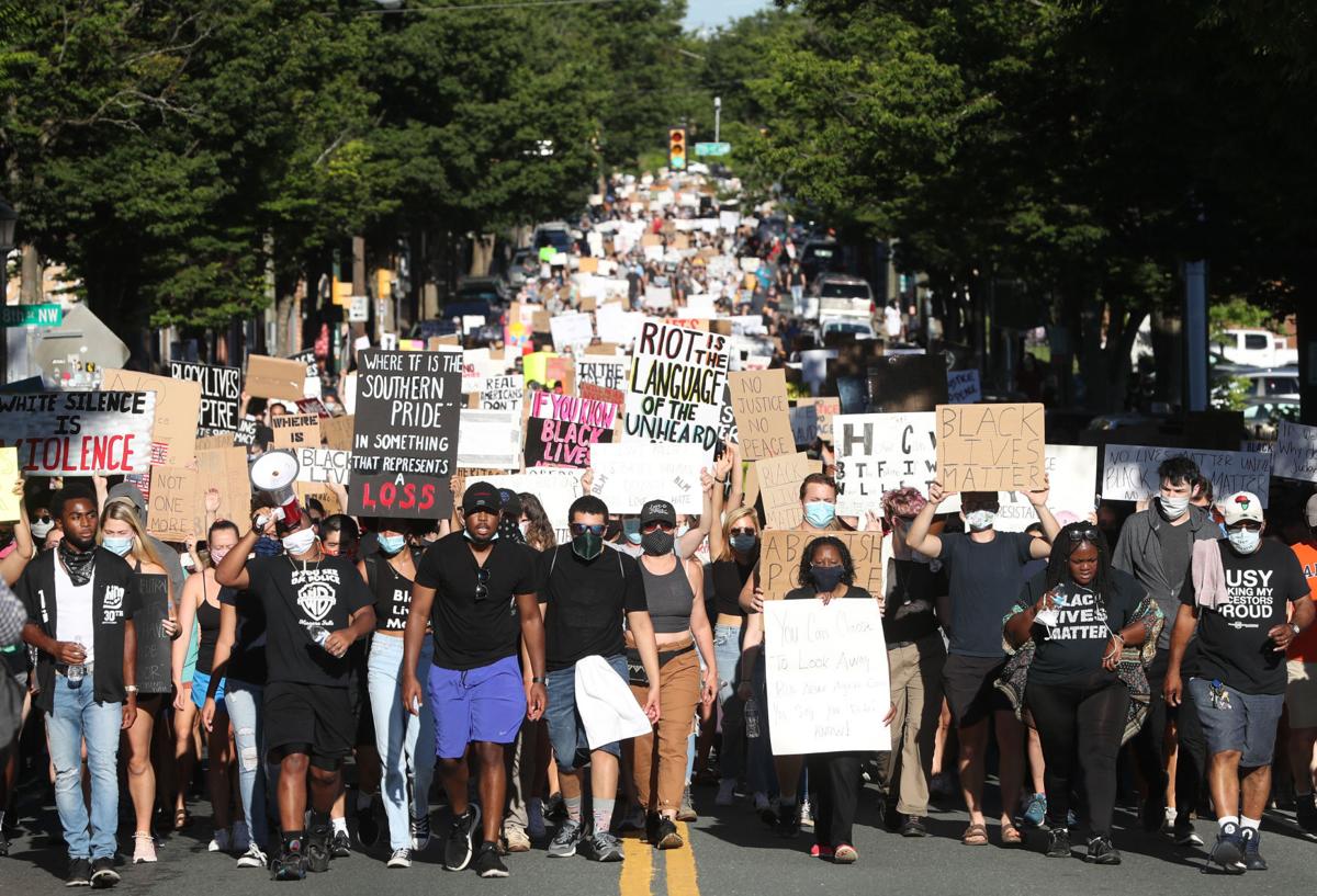 An estimated 1,000 people march from downtown Charlottesville to UVa