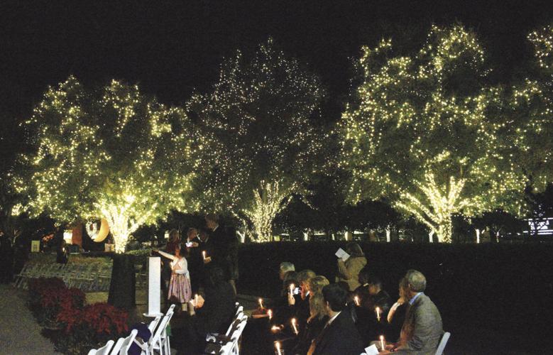 McLeod Hospice Tree Lighting a sign Christmas is here