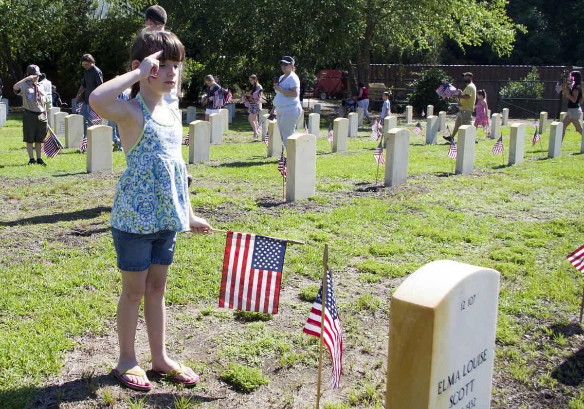 Flags placed on graves for Memorial Day