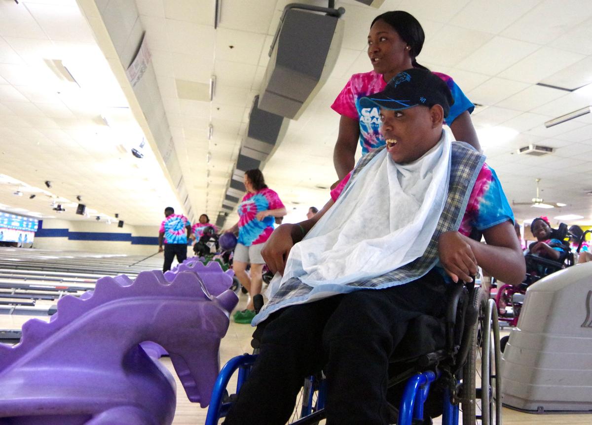Campers with disabilities have fun on bowling outing