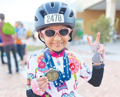 Cyclist, 7, beats sister’s record in 102-mile bike race | Neighbors ...