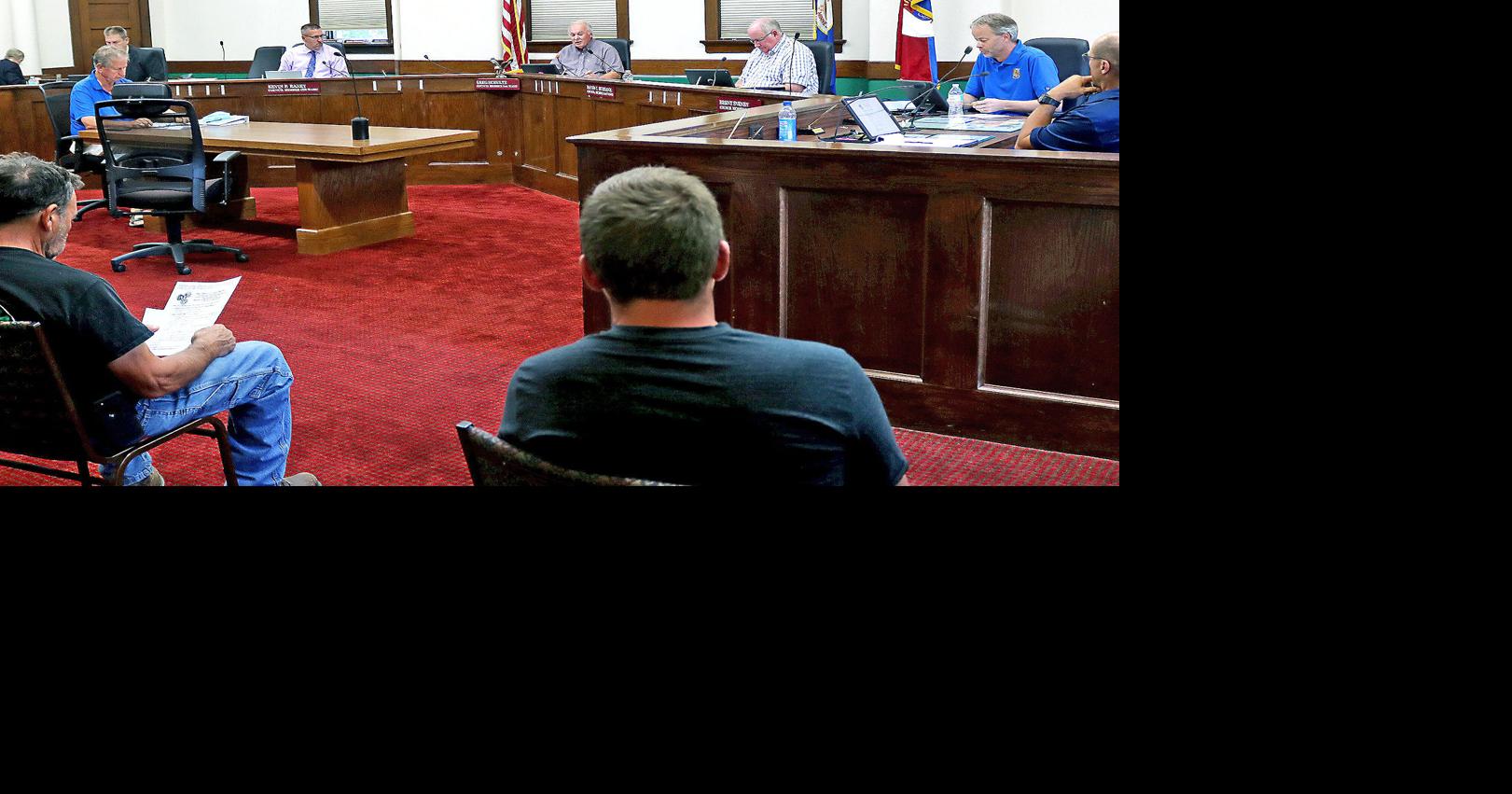 Local officials prioritize social distancing over masks at government ...