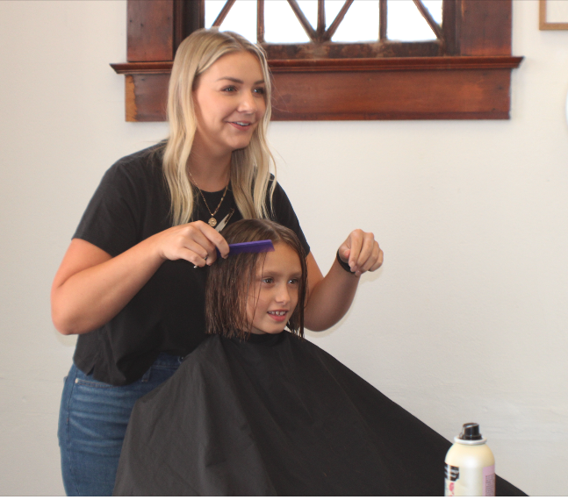 Frey gives girls free haircare in Cuts with a Cop | News | southernminn.com