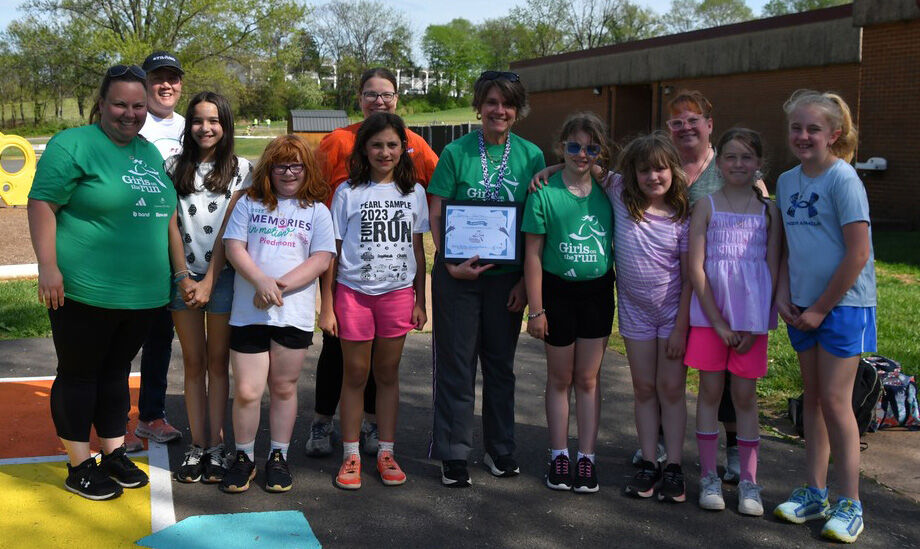 School employee earns 10-year pin as Girls on the Run coach, mentor
