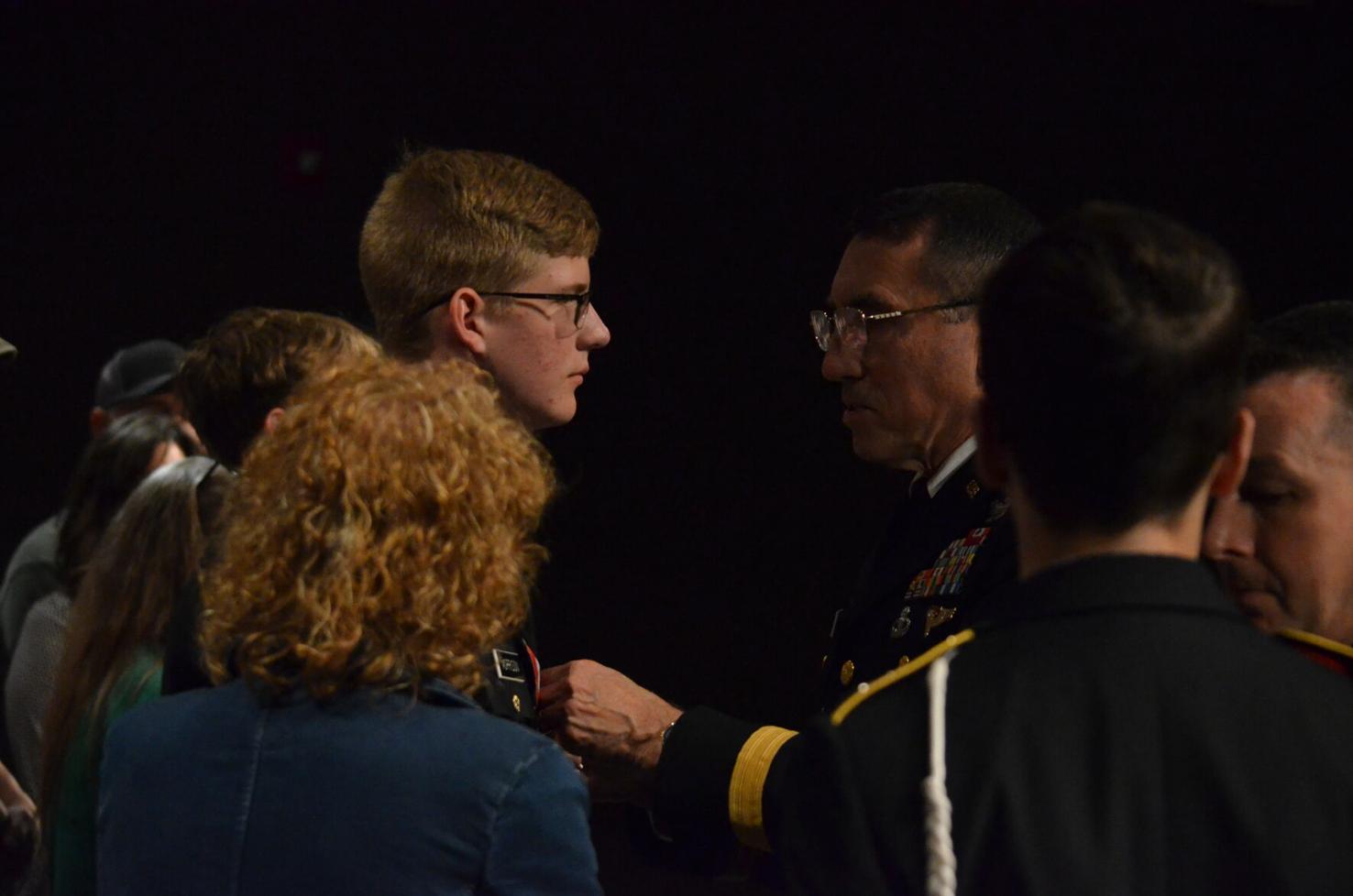 Cameron Morrison has the Army JROTC Medal of Heroism pinned on him by Gen. James Mallory at the ...