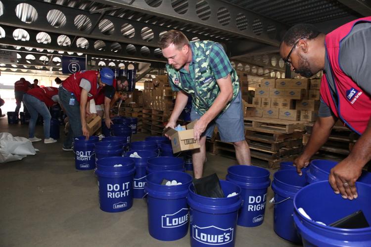 Lowe's employees fill pails with disaster relief supplies