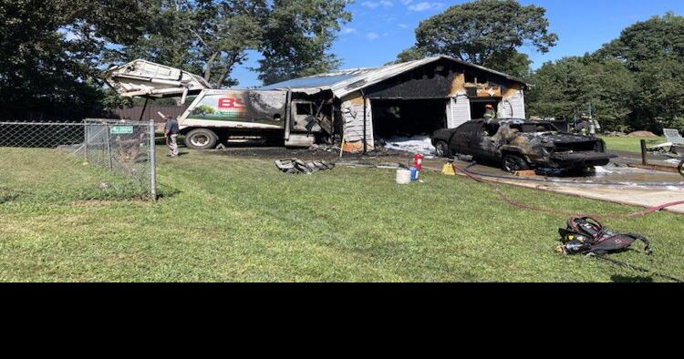 Garage, vehicles damaged after sanitation truck hits building