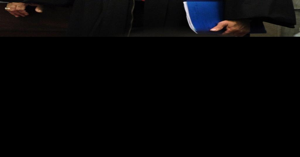 Judge George W. Draper, III, laughs while listening to his daughter