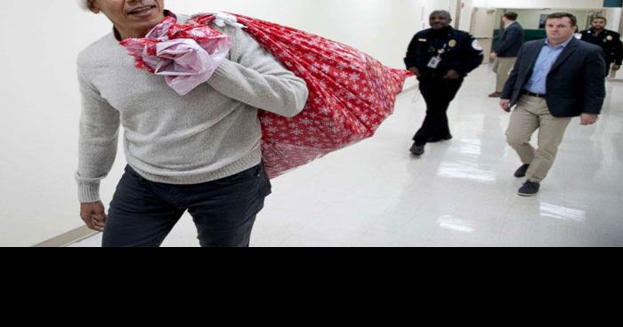 Surprise Santa as Obama visits children's hospital with gifts