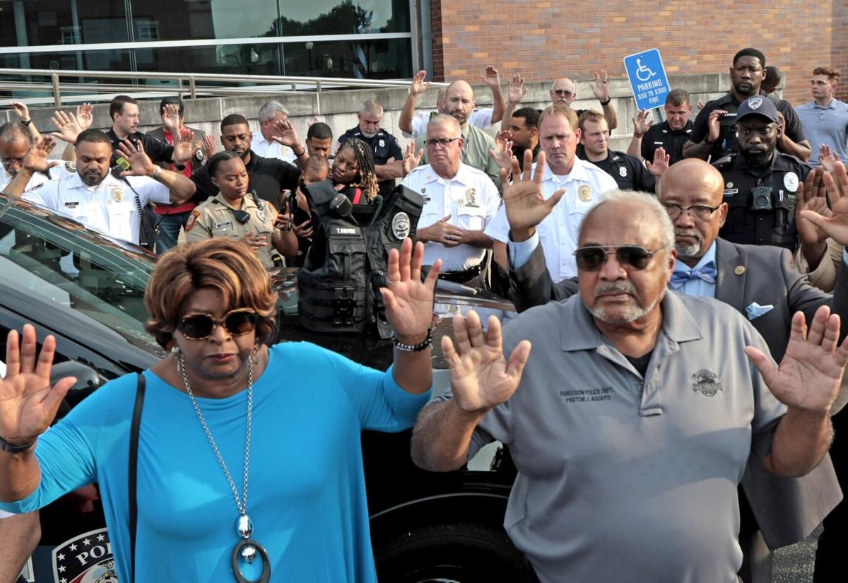 Officials, community members gather at vigil for Ferguson police ...