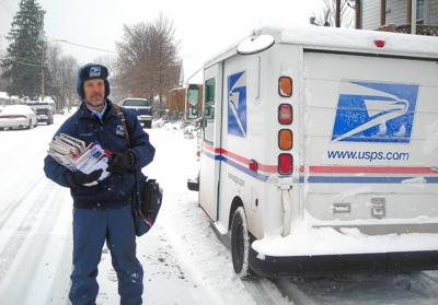 ON THE JOB: Mailman shrugs off snow