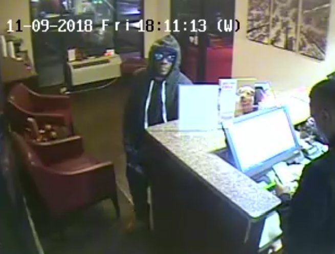 Surveillance image shows gunman robbing Red Roof hotel in St. Louis