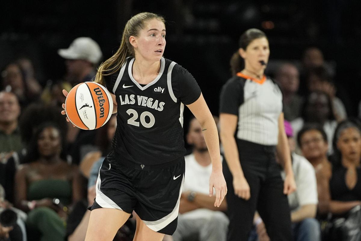 Kate Martin, A.J. Epenesa share a moment during WNBA game