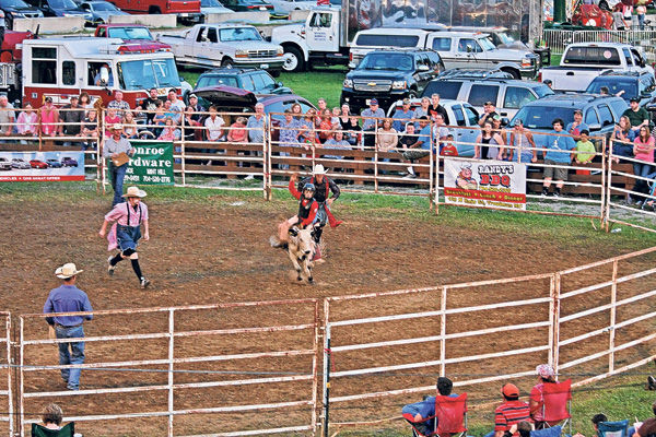 Bull riders wrangle in the crowd in Bland County