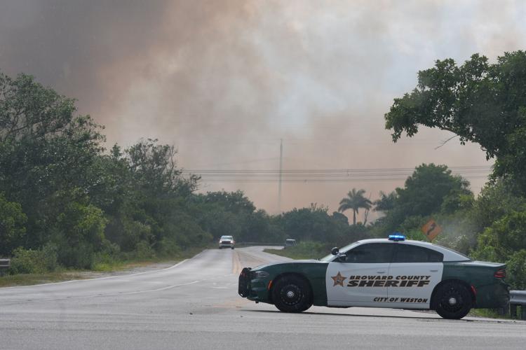 Crews battle South Florida wildfires that have burned thousands of ...