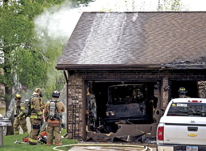 1 person treated after vehicle fire spreads to garage of Dubuque home ...
