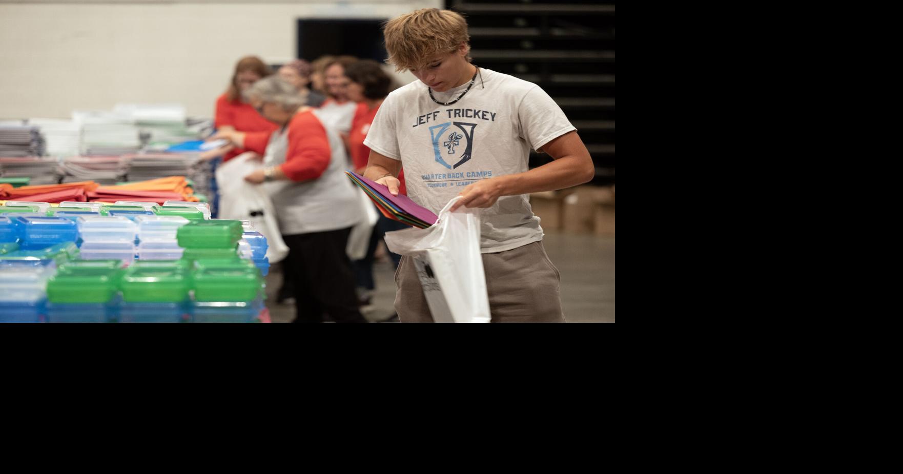 Volunteers in Dubuque pack bags of school supplies for St. Mark ...
