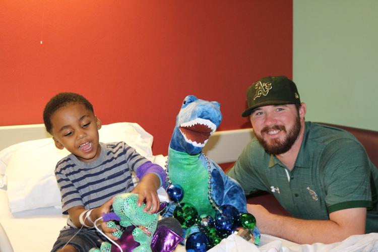Ex-UL pitcher Hogan Harris brings some Mardi Gras spirit to kids ...