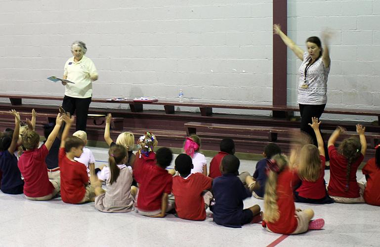 Busy Bees volunteer group distributes book bags at elementary school ...