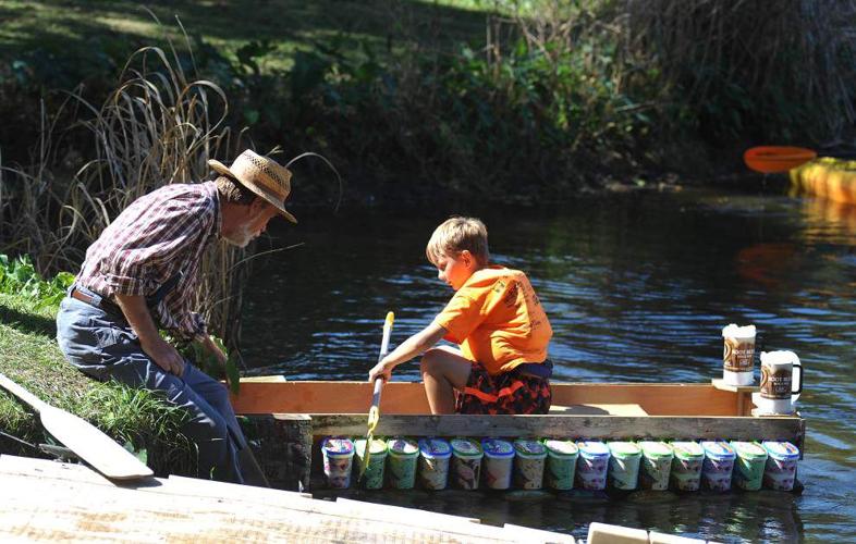 Spectators line the banks of Bayou Vermilion Sunday to watch the boat ...