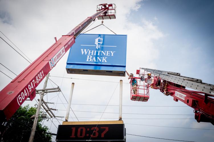 Whitney officials hang new sign on former First NBC branch in Metairie ...