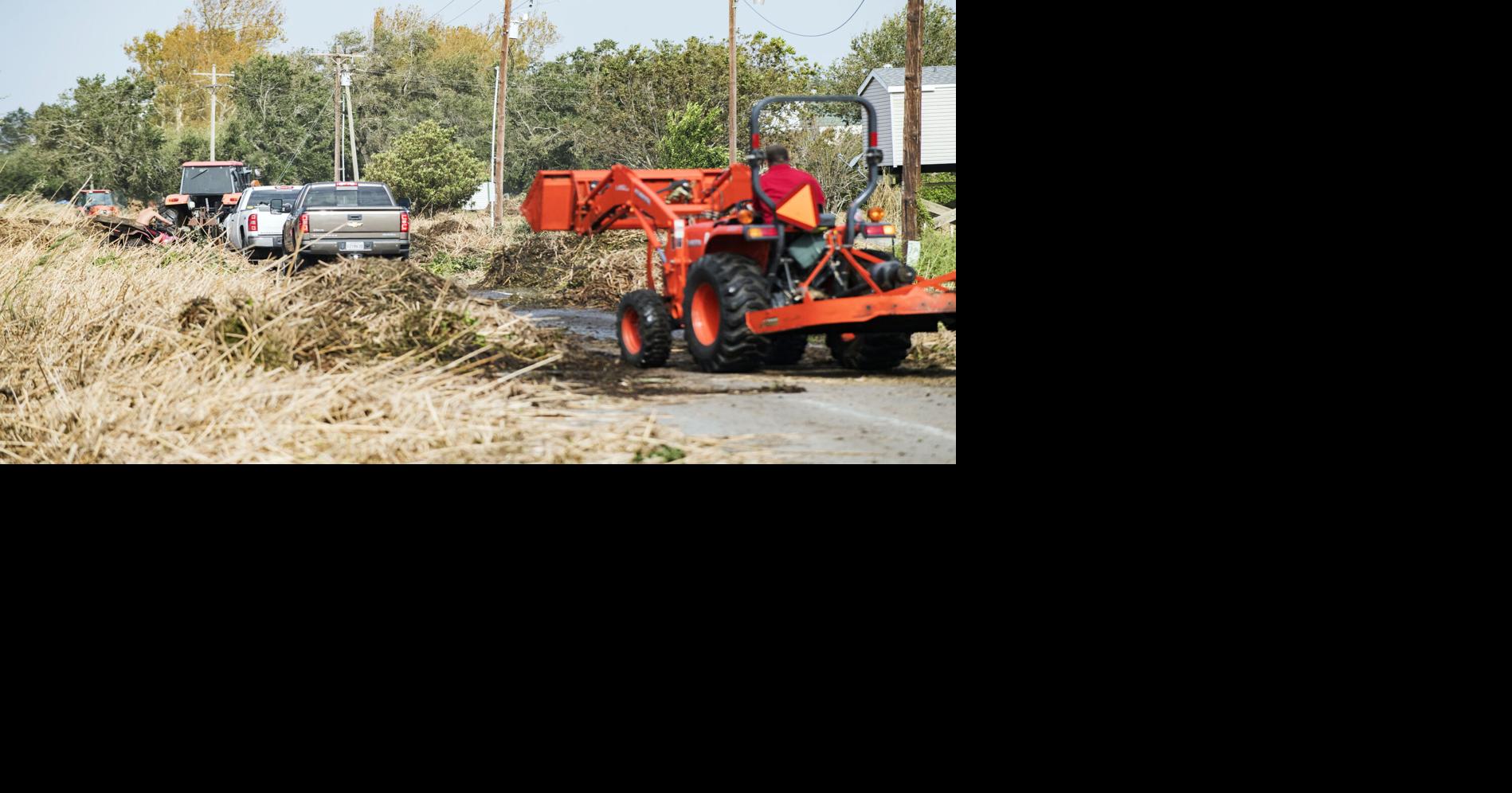 Vermilion Parish residents, camp owners, plow path through marsh grass ...