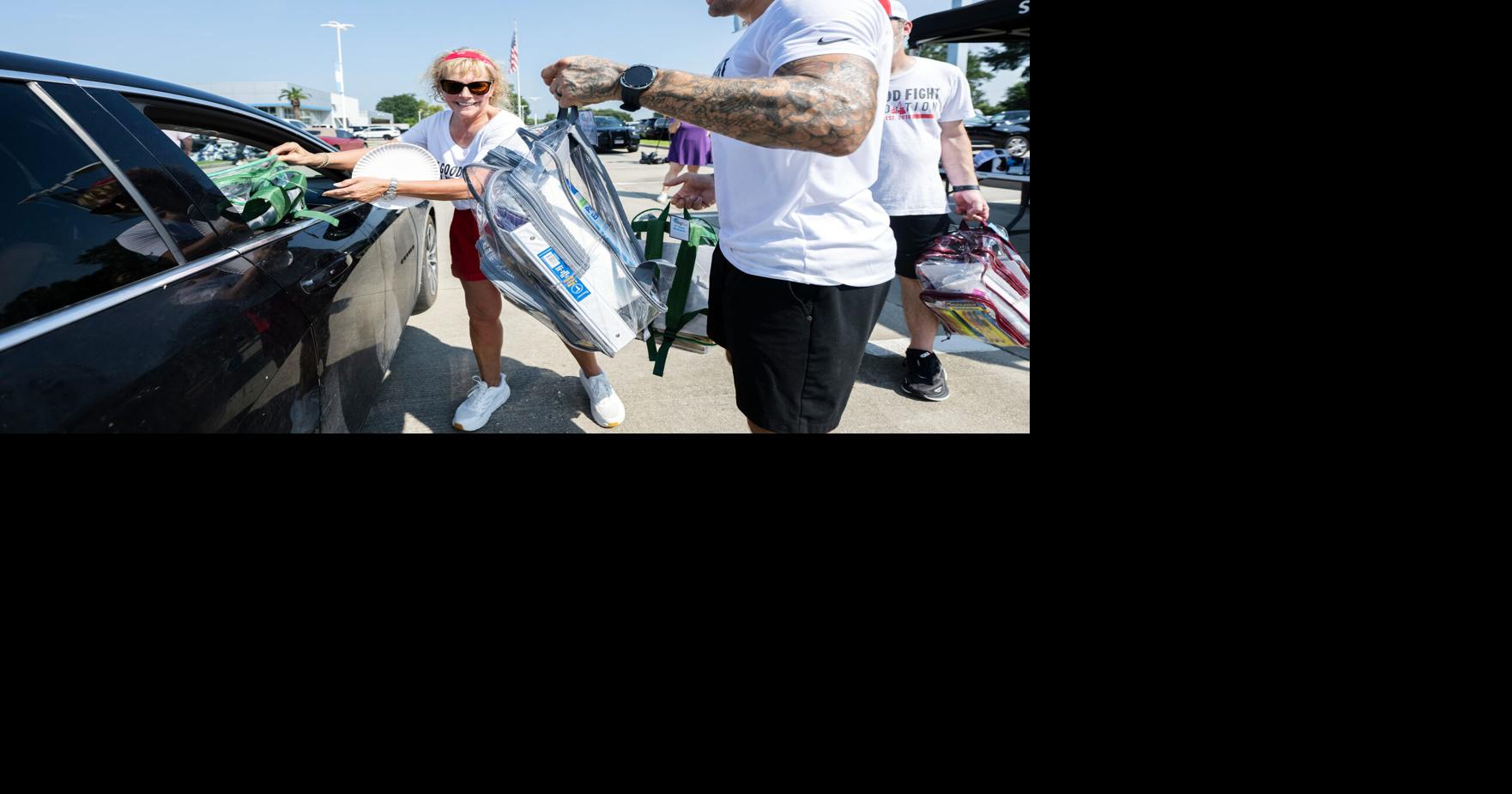 UFC Fighter Dustin Poirier, volunteers hand out backpacks | Photos ...