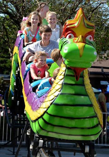 Flying horses, sliding dads, rolling dragons at St. George Fair ...