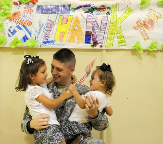 Returning soldier surprises daughters at preschool | Zachary ...
