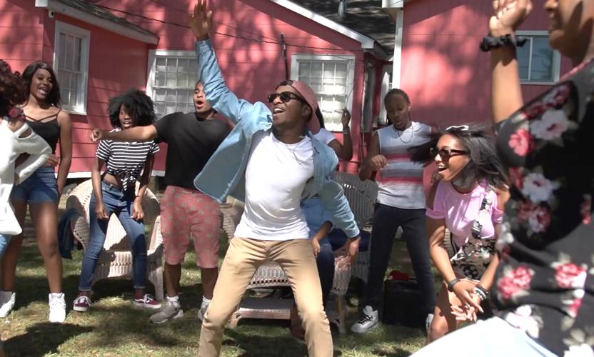 A family gathers around a table for food and dance in New Venture ...