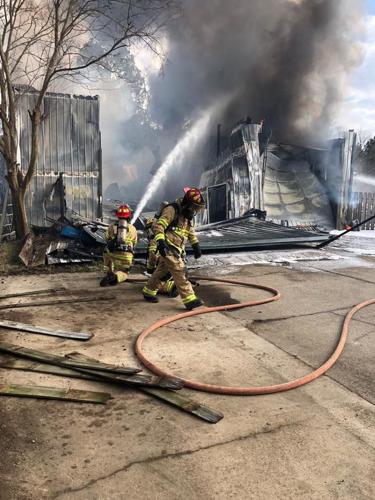 Civilians help rescue firefighter after overhang roof collapses ...