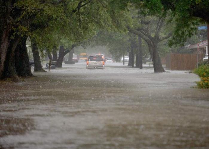 Flooded streets and floating garbage cans: Photos of Friday's soggy ...