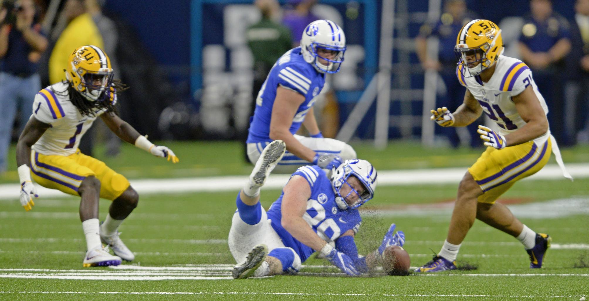 LSU players support injured safety Ed Paris with his name scribbled on ...
