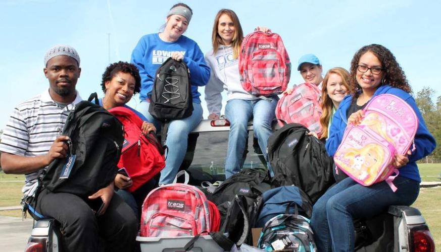 Lowery staff surprises elementary students with backpacks, holiday ...