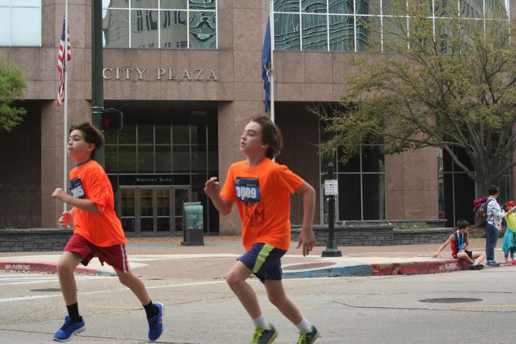 Baton Rouge FLAIM's Run Club ends year with check from mini marathon ...