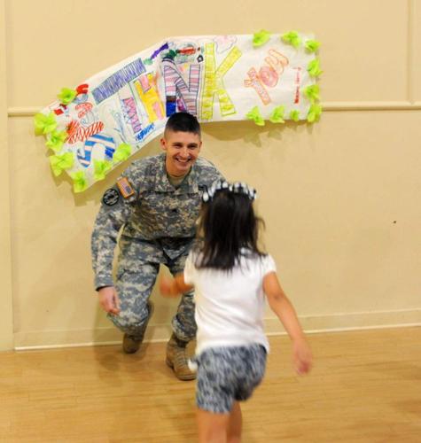 Returning soldier surprises daughters at preschool | Zachary ...