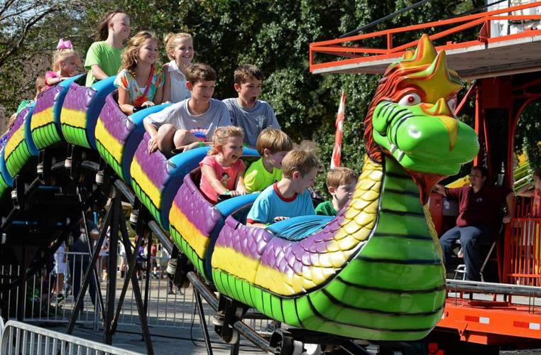 Flying horses, sliding dads, rolling dragons at St. George Fair ...