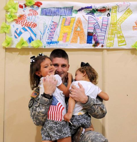 Returning soldier surprises daughters at preschool | Zachary ...